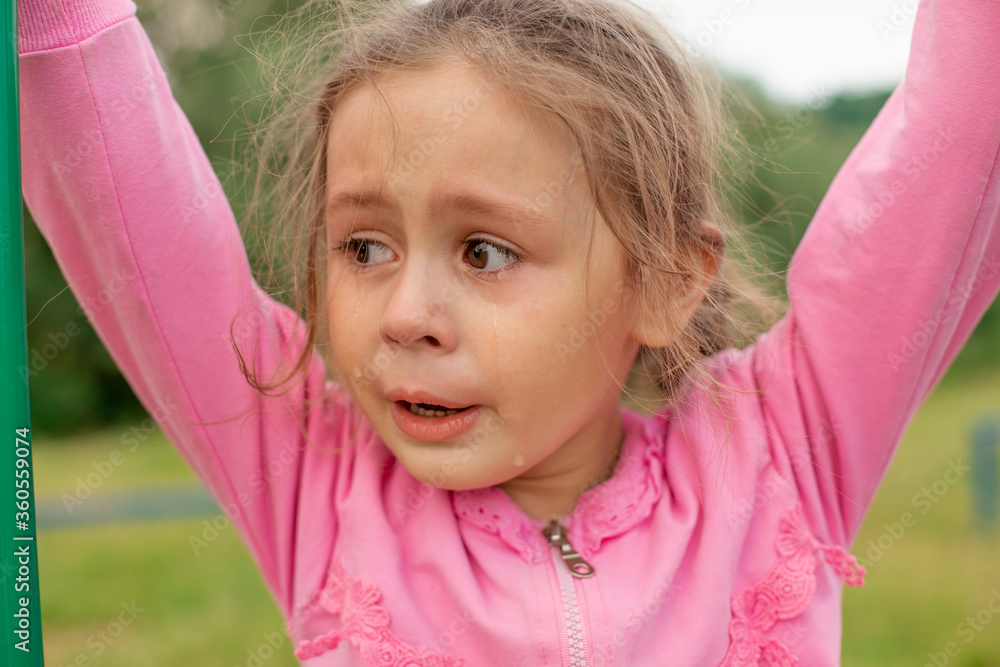 Little girl crying sitting on a swing at the playground Stock Photo ...