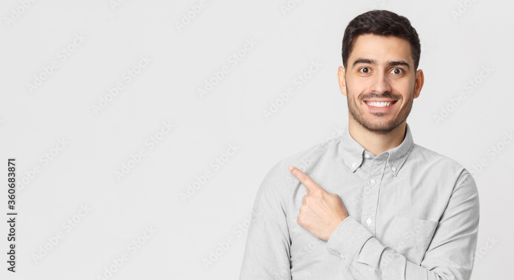 Banner of excited young man in shirt pointing with finger to left side ...