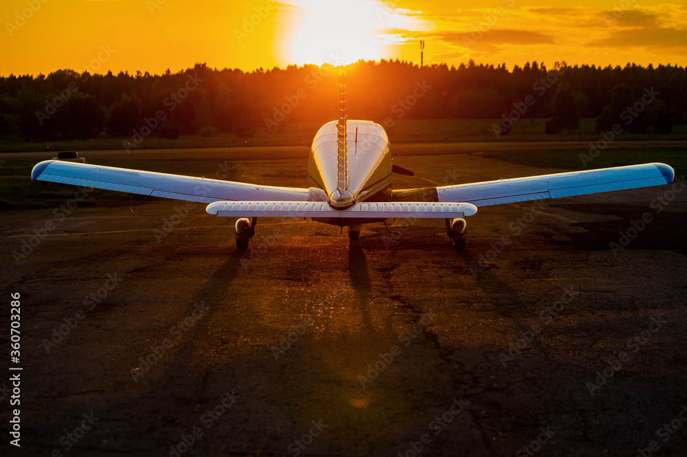 Quadruple aircraft parked at a private airfield. Rear view of a plane ...