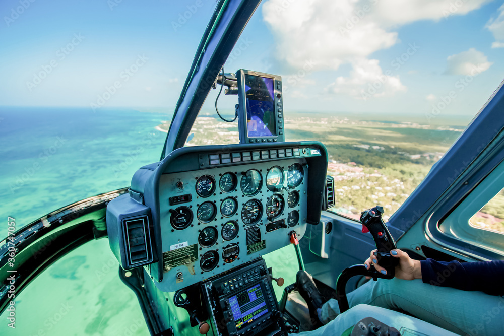 Helicopter cabin inside cockpit aerial top view on blue sky and water ...