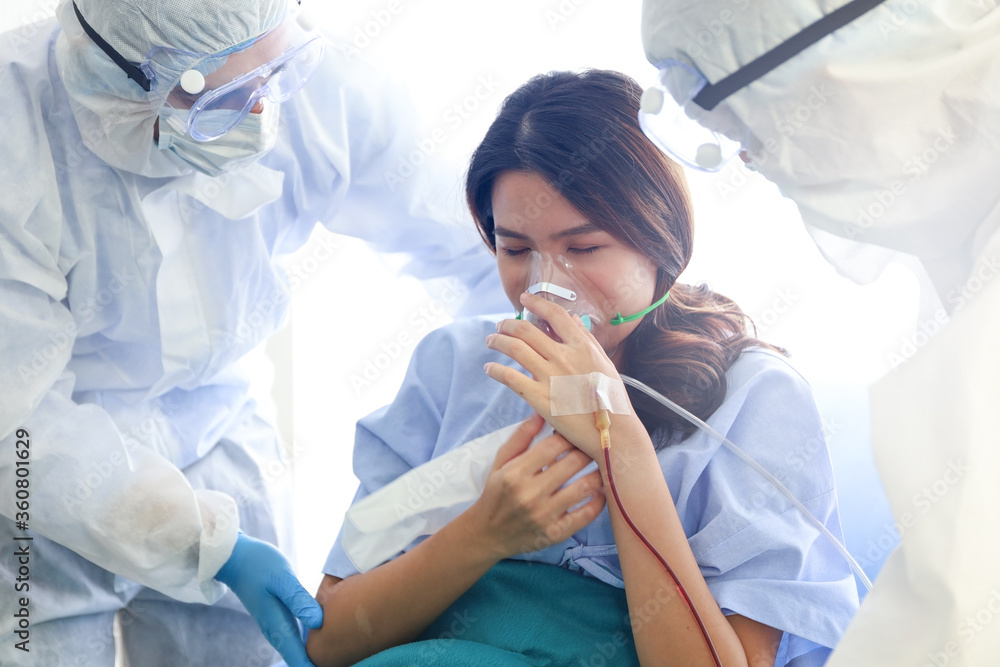 A patient woman wear face mask and cure on bed and covid-19 emergency ...