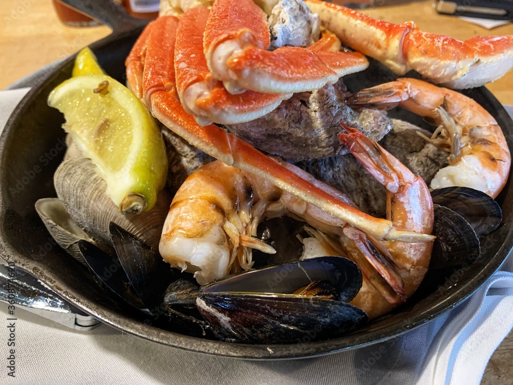 Steamed seafood sampler pan with clams, oysters, shrimp, mussels, and ...