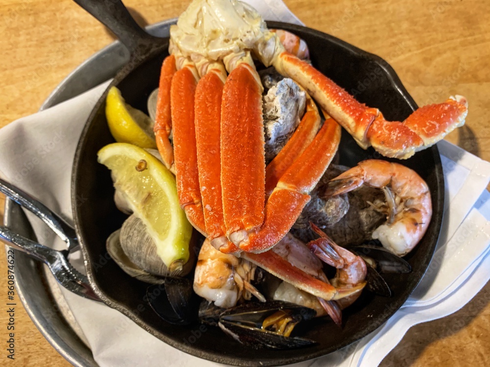Steamed seafood sampler pan with clams, oysters, shrimp, mussels, and ...