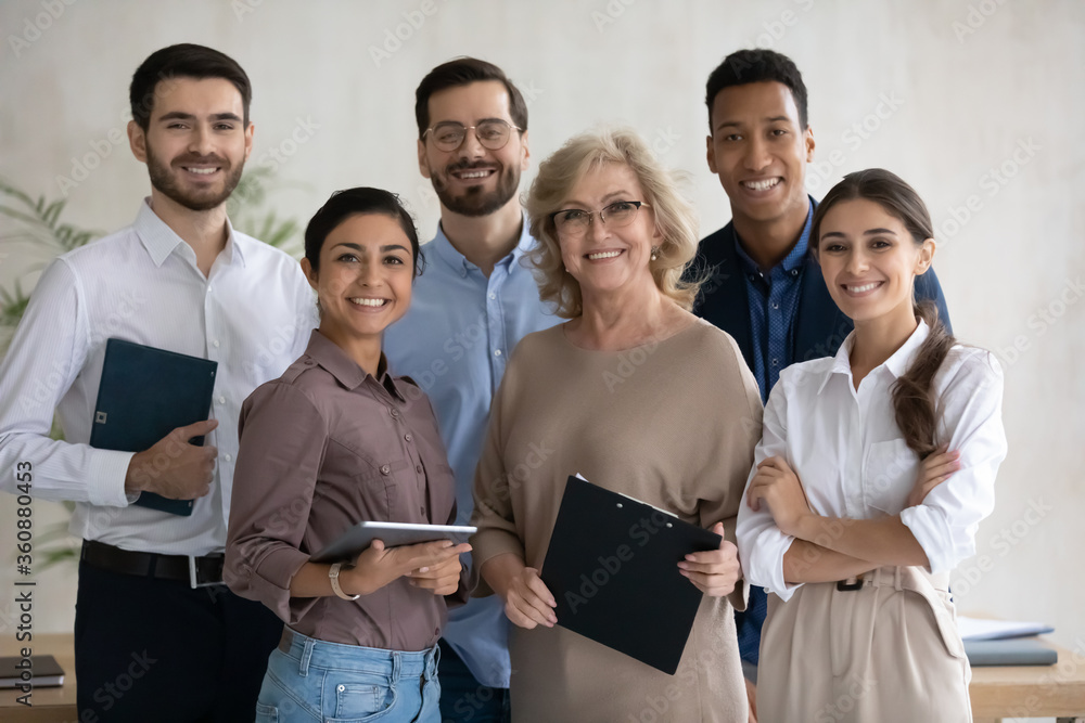Corporate portrait smiling diverse employees team standing in office ...