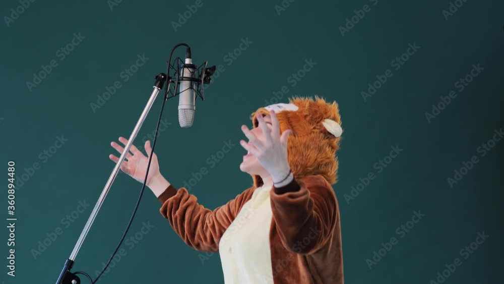 The young adult female with lion costume plays some role during voice ...