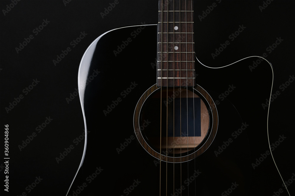 Black acoustic guitar studio shot on black background with copyspace ...