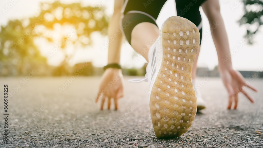 Rear view close up at sport shoes of young athlete woman in starting ...