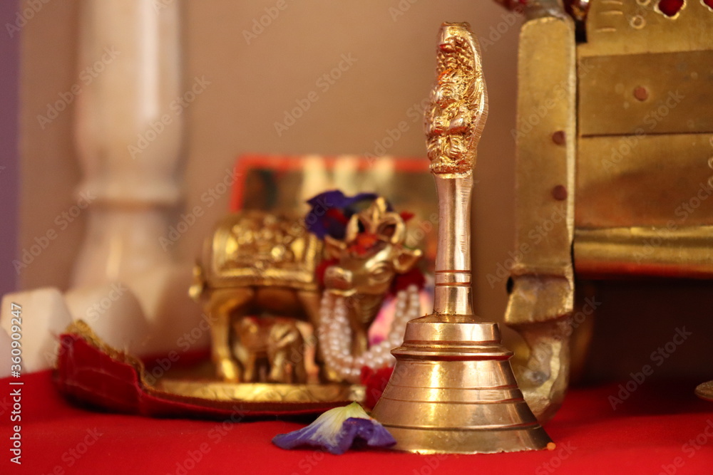 Stock photo of a brass pooja room bell with temple deity in background ...