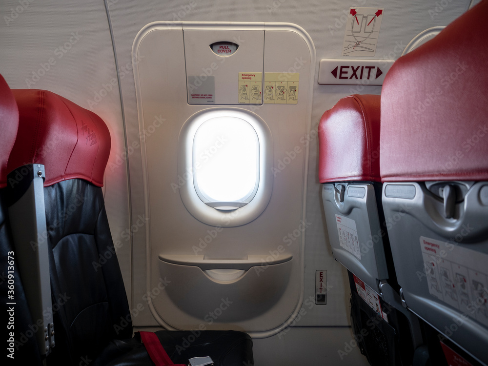Emergency exit window in aircraft cabin. Long leg room seat. premium ...