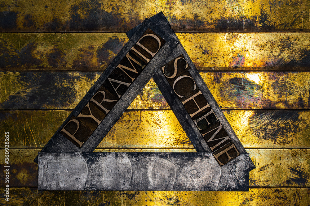 Pyramid Scheme text formed with real authentic typeset letters on ...