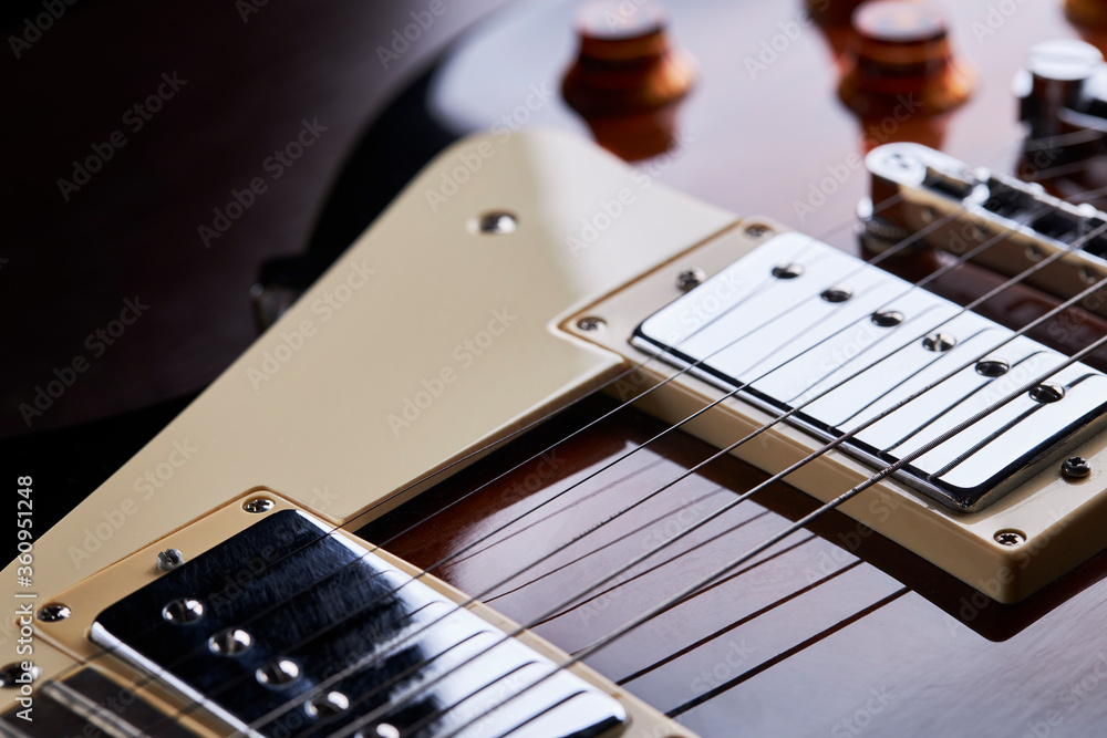 high contrast close up view for electric guitar. side view. music still ...