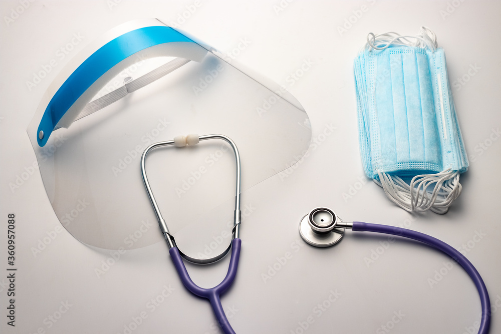 Doctor personal protective equipment concept. Stethoscope, face shield ...