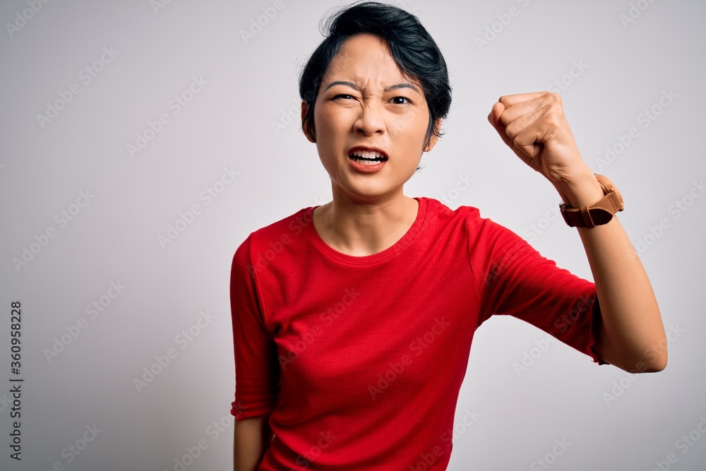 Young beautiful asian girl wearing casual red t-shirt standing over ...