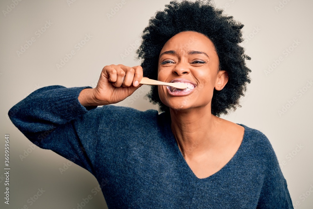 African american woman brushing her teeth using tooth brush and oral ...