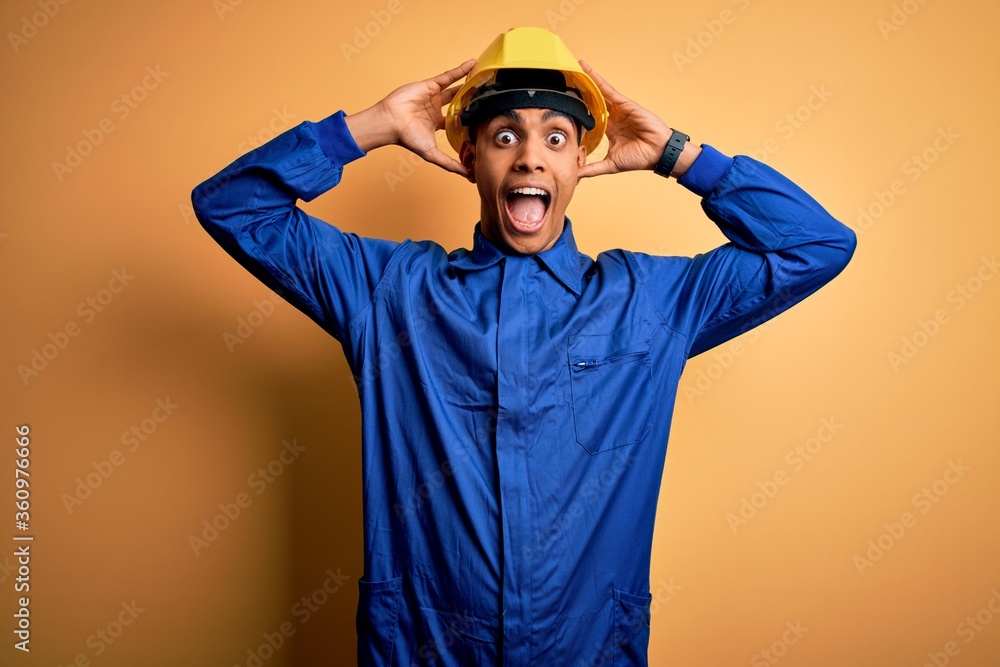 Young handsome african american worker man wearing blue uniform and ...