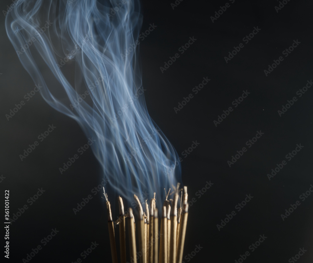 Incense burning incense, white smoke, black background, used as ...