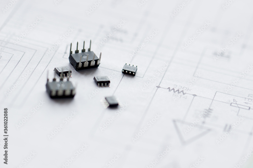 Electronic parts on the background of the schematic diagram. Microchips ...