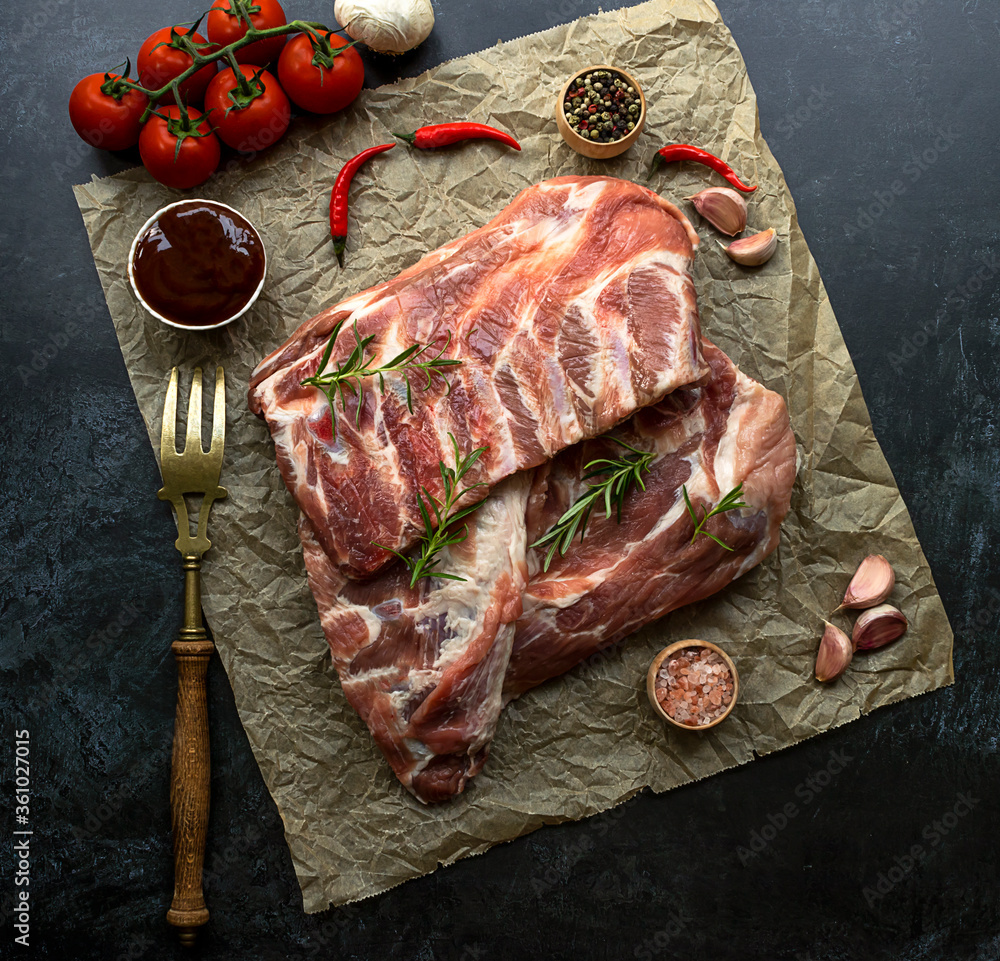 Rack of raw pork spare ribs seasoned on a crumpled paper with smoked ...