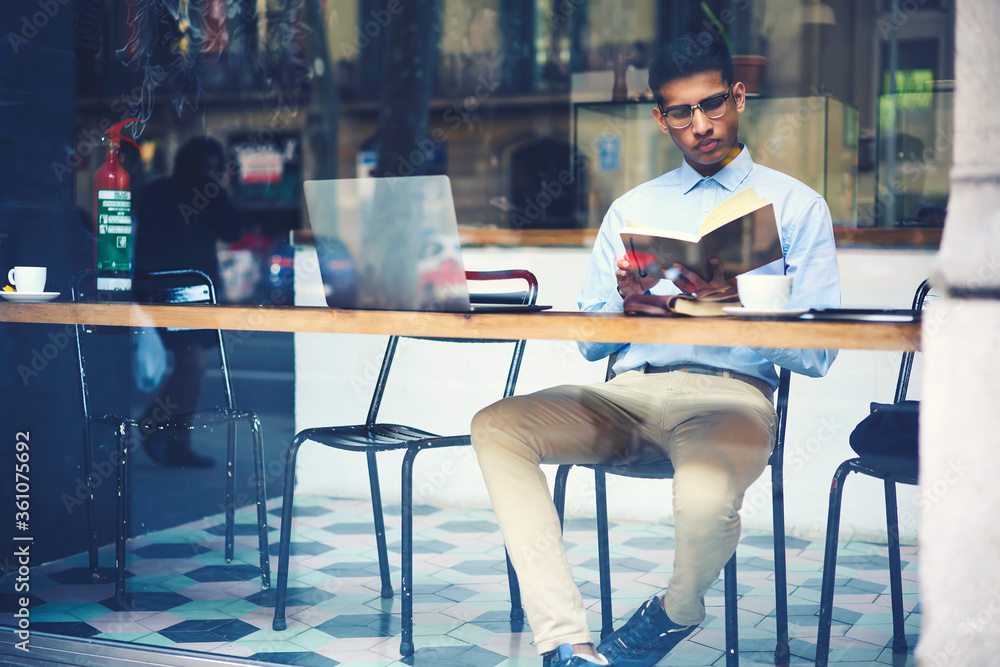 Serious concentrated male international student preparing for upcoming ...
