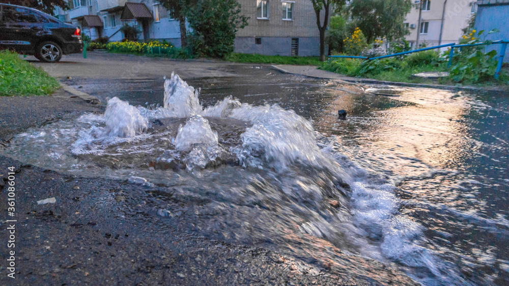 Dirty sewage water flows fountain on road from sewer manhole Stock ...