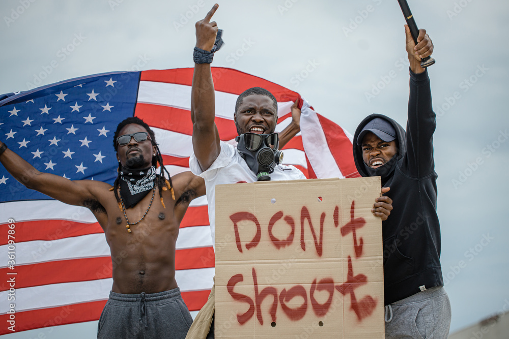 Demonstrators hold banners with the motto of the black civil rights ...