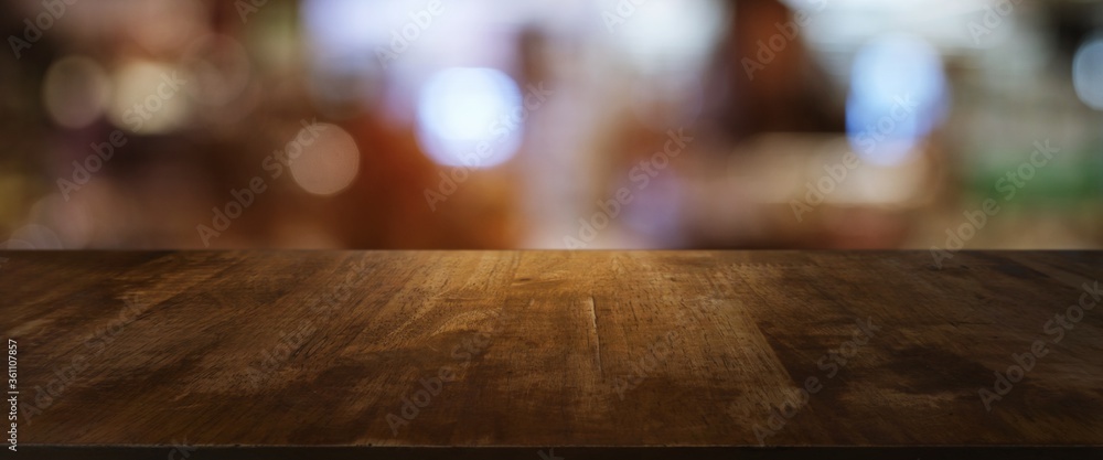 Empty dark wooden table in front of abstract blurred bokeh background ...