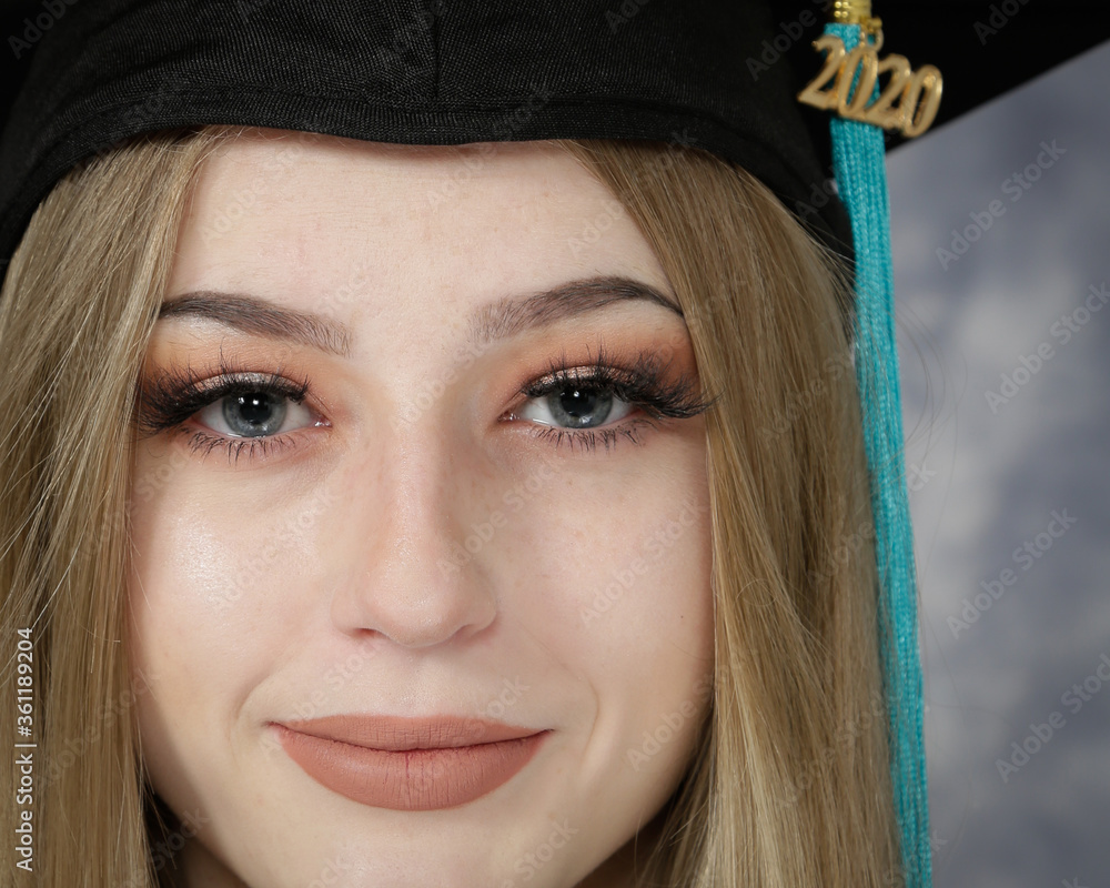 female high school graduate, class of 2020 in black cap with turquoise ...