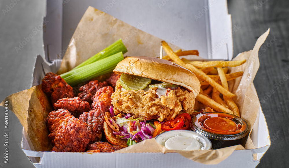 take out box with fried chicken sandwich, boneless wings and french ...