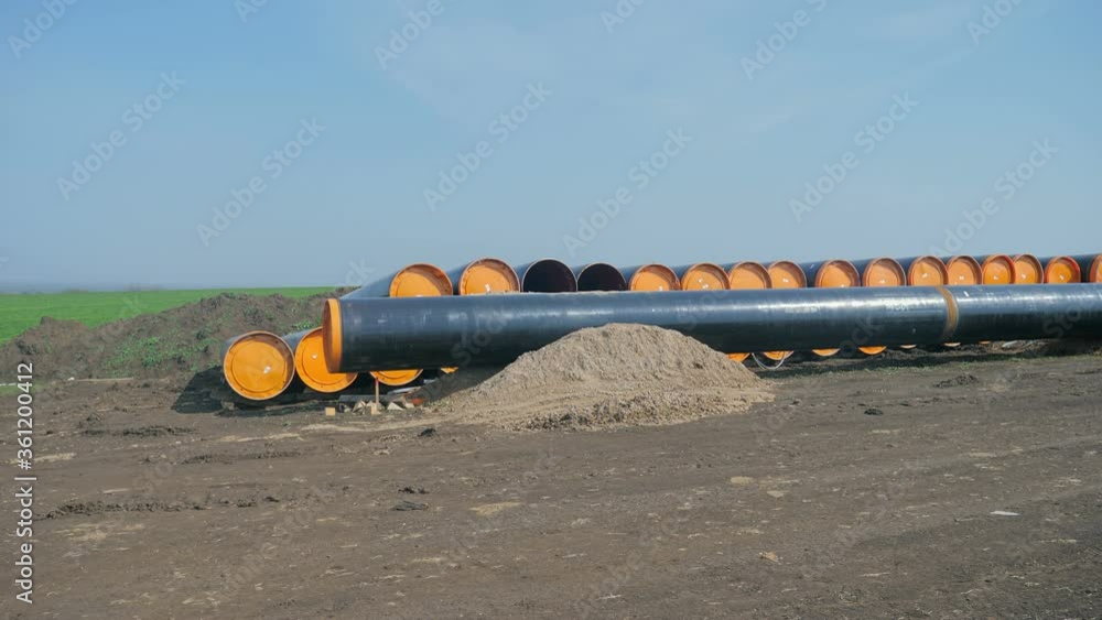Natural gas pipe line. Pipes welded together, are laid on top of ...