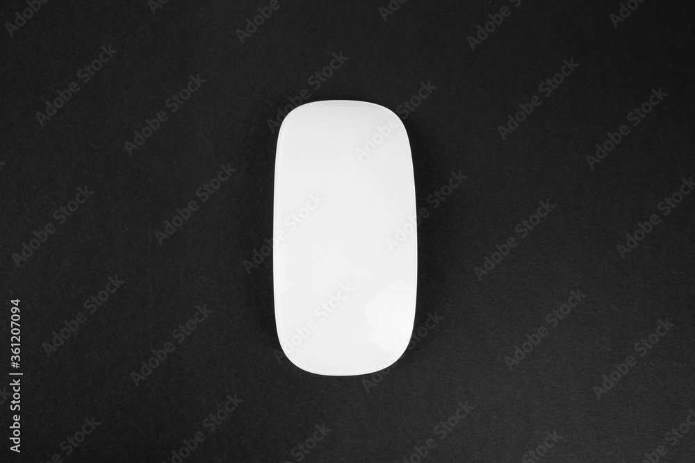 White wireless computer mouse on black background. Modern sleek design ...
