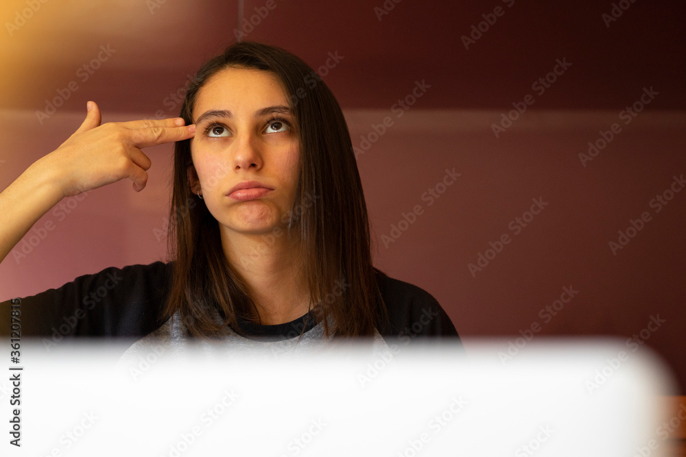 Woman making a gun gesture with her hand. Concept of stress at work ...