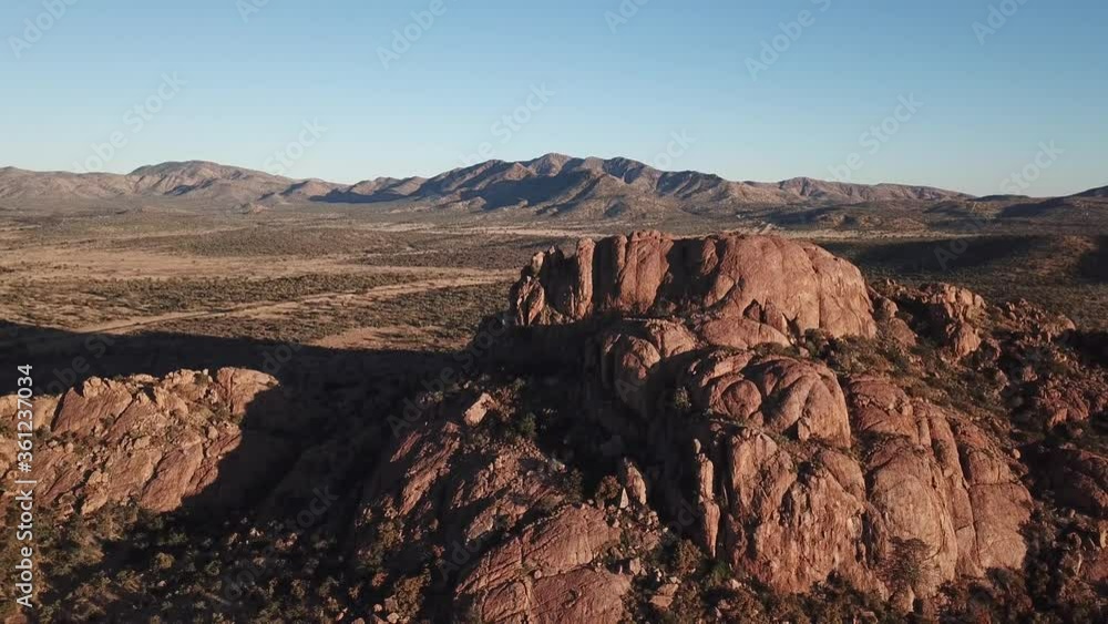 4K aerial drone video of African savanna hills, large red granite ...