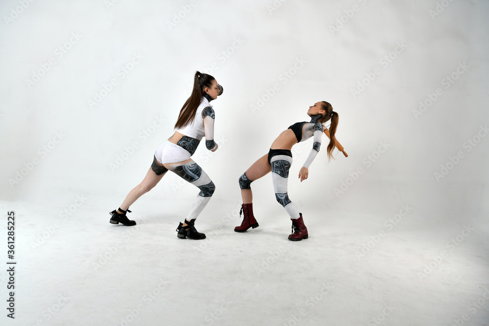 beautiful girls in costumes of robots quarreled and fight with a ...
