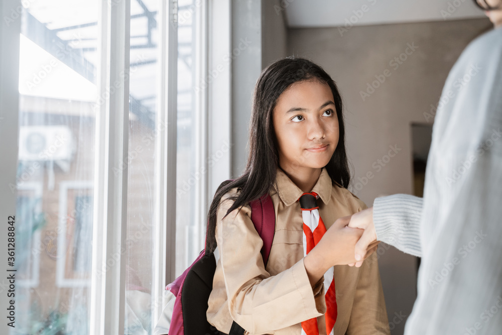 girl scout shake her mother hand before going to school Stock Photo ...