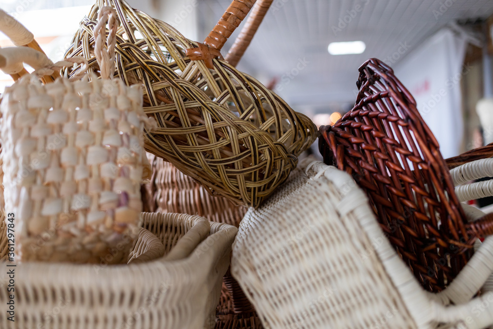 plenty of wicker baskets of different colours on the counter. High ...