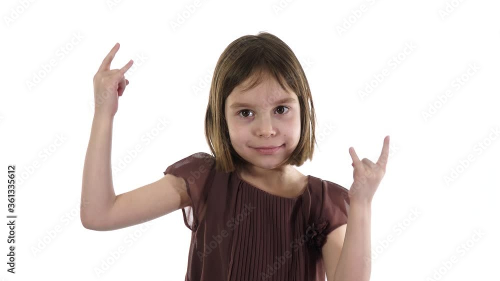 Rock N Roll hand gesture. Little girl shows Rock N Roll hand sign while ...