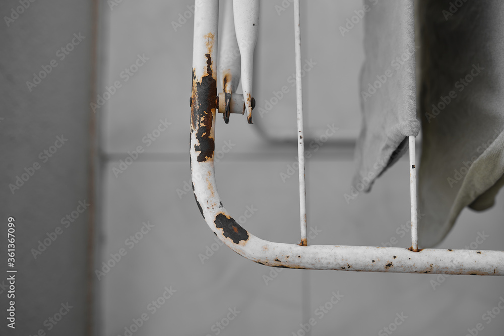 Rusty, worn stainless steel clothes drying rack Stock Photo | Adobe Stock