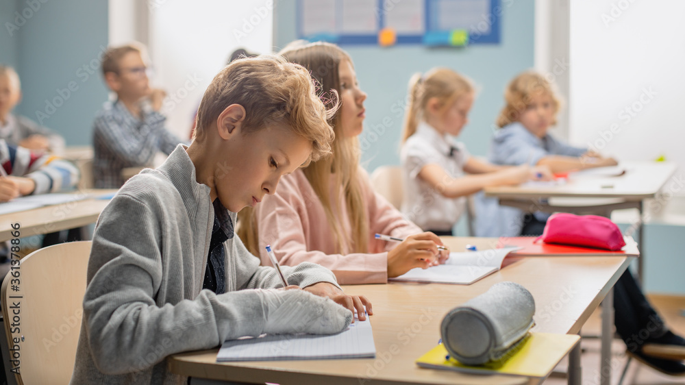 Elementary Classroom of Diverse Children Listening Attentively to their ...