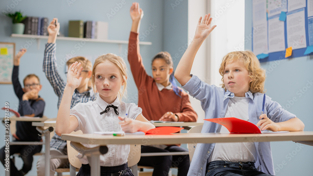 Elementary Classroom of Diverse Children Listening to the Teacher ...