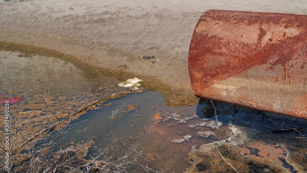 Drainage system of sand quarry, water flows from big metal pipe Stock ...