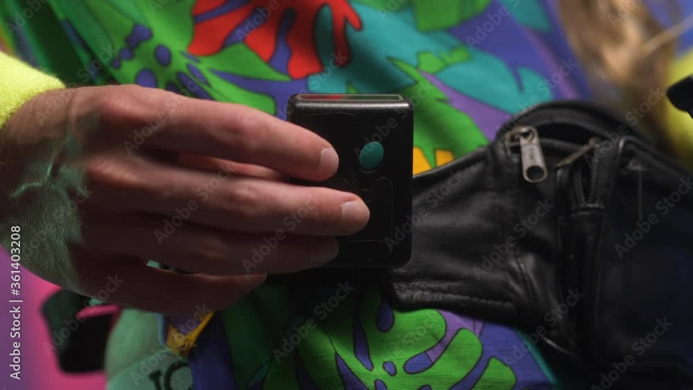 Checking a pager device in the 80s 90s looking at the unit and pressing ...