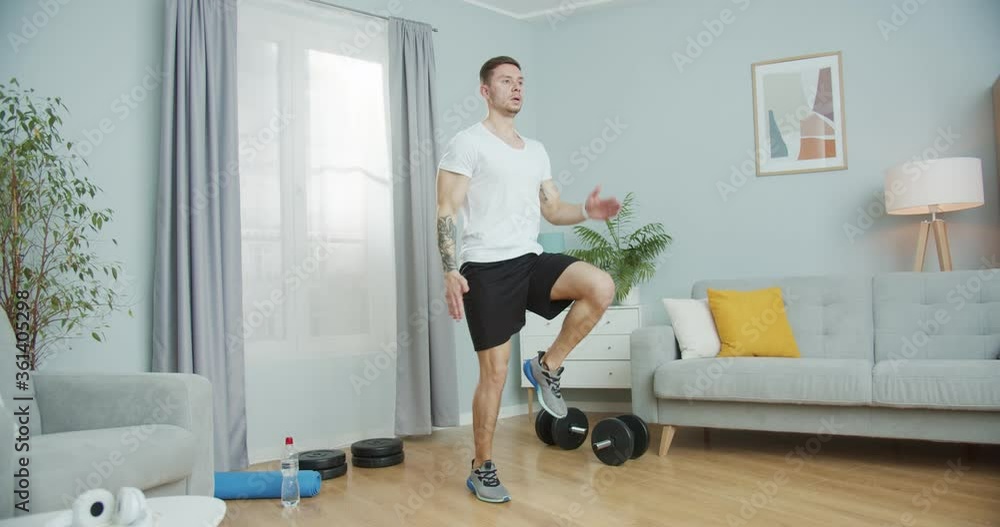 Strong athlete working out, training at home. Attractive male doing ...