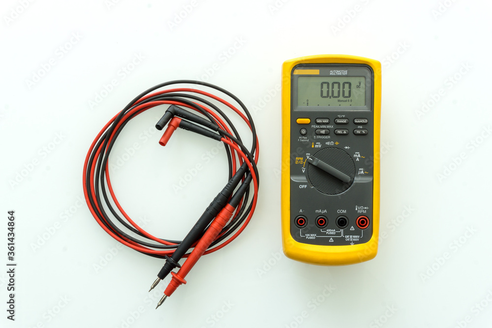 Yellow Digital multimeter with probes for measuring voltage, current ...