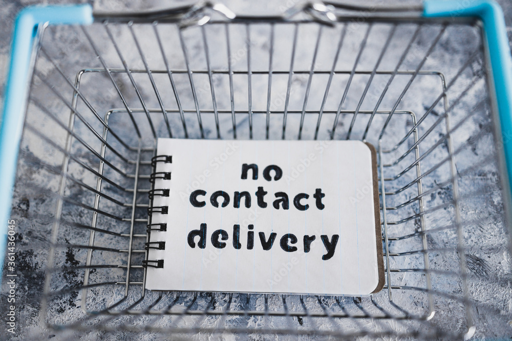 No Contact Delivery text on notepad inside shopping basket symbol of ...