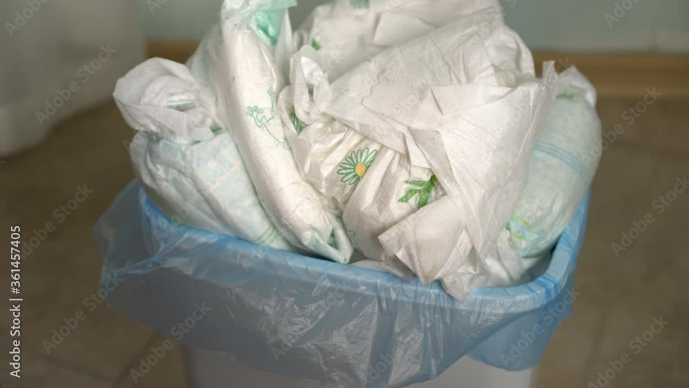 Dirty baby diapers in the trash. Disposing of used nappies. The problem ...