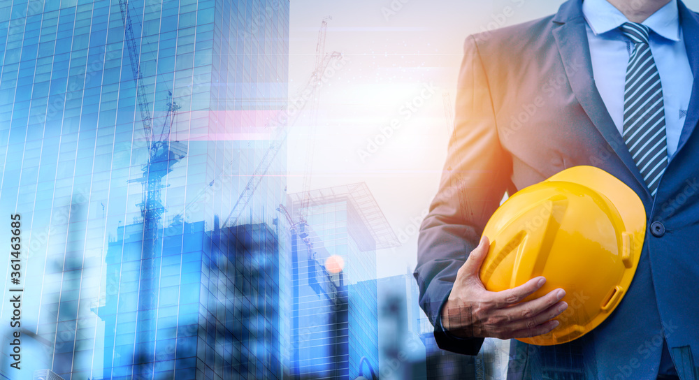 Double Exposure of building under construction and man engineer is ...