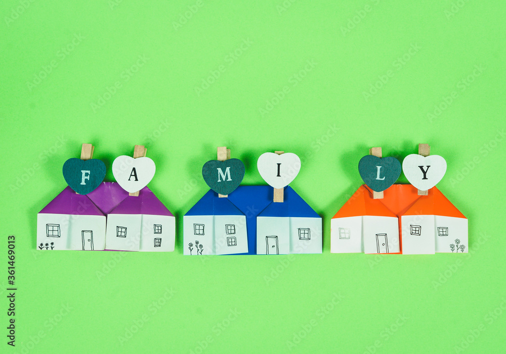 Family concept. Letters that form the word family, with papers houses ...