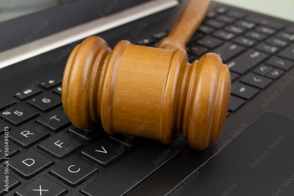 Wooden judge gavel on laptop computer, cyber law or crime concept Stock Photo | Adobe Stock