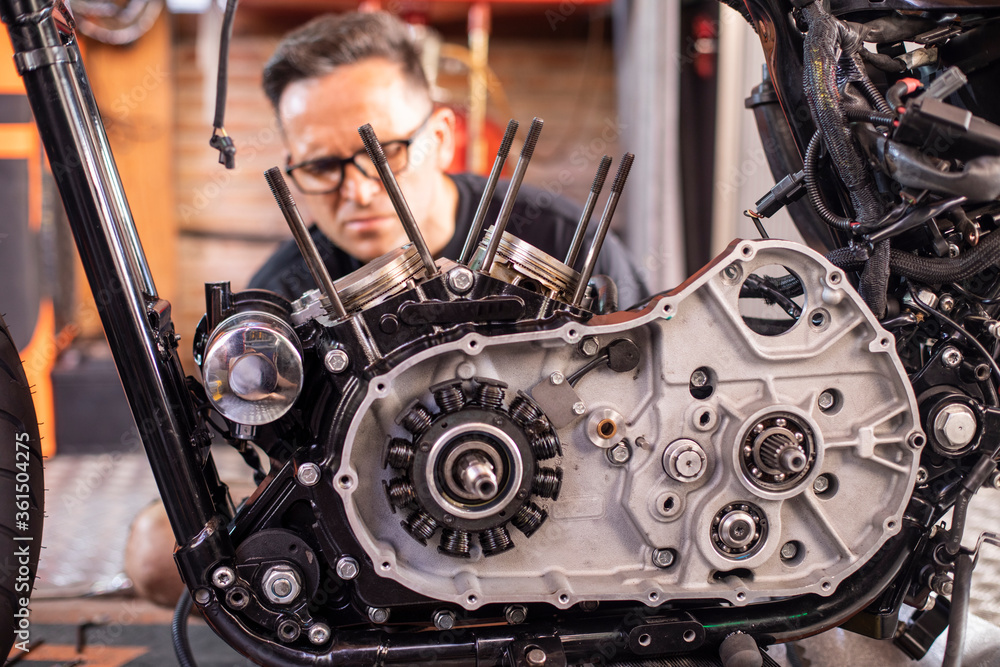 mechanic working on the repair of a motorcycle in the workshop Stock ...