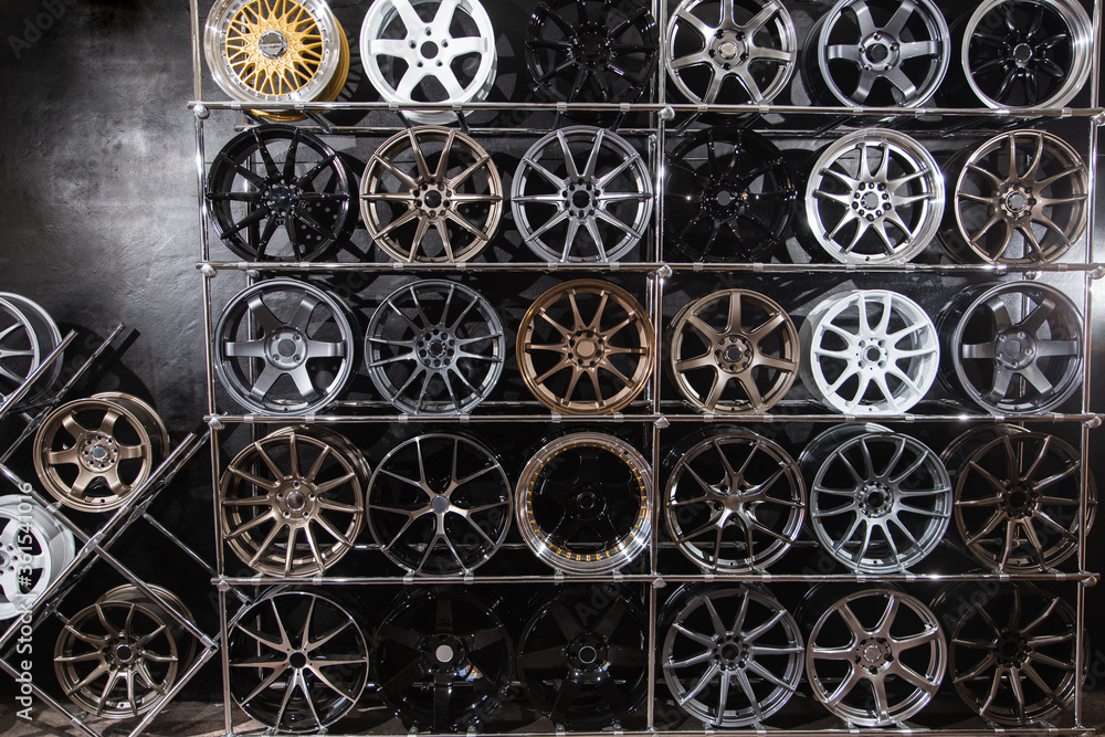 wall of alloy wheels in the store. Auto repair shop background. Auto ...